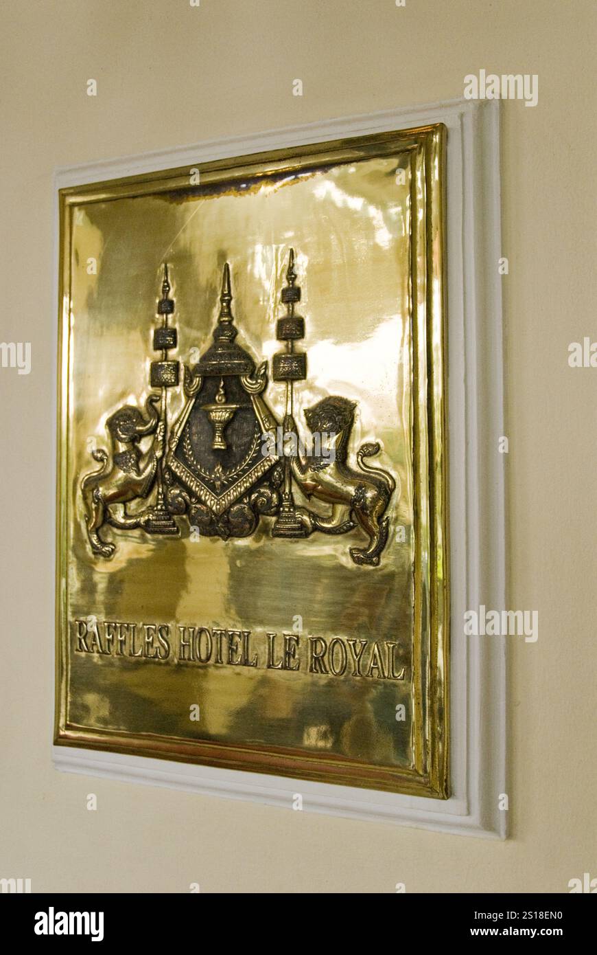 A brass sign next to the entrance to the Raffles Hotel Le Royal, is a ...