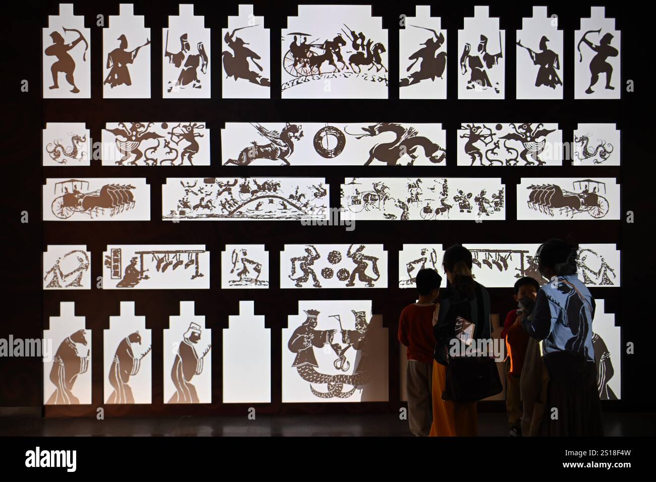 Beijing, China. 1st Jan, 2025. Visitors watch an exhibition themed on ...