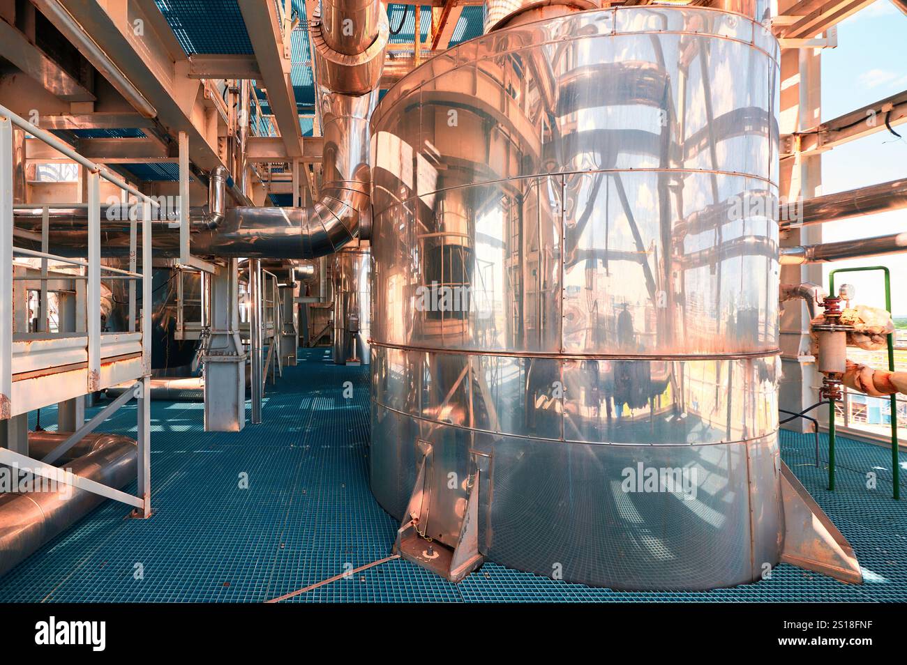 Inside a modern chemical plant with intricate pipelines and processing ...
