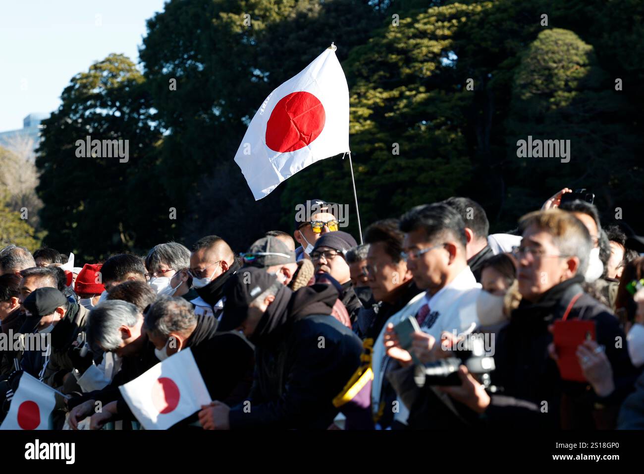 Tokyo, Japan. 2nd Jan, 2025. People holding Japanese flags wait to ...