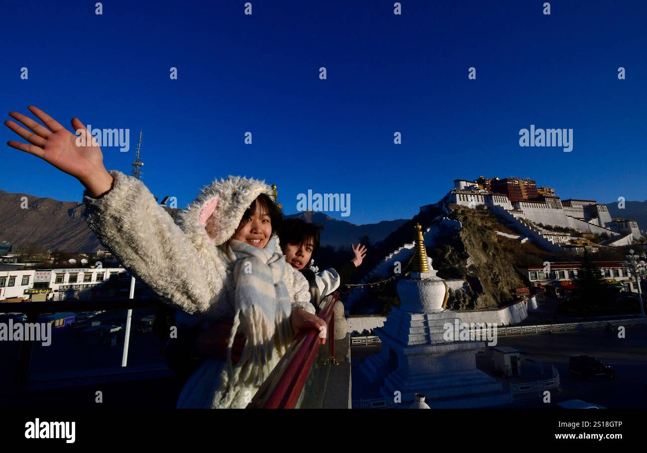 Lhasa,China.1st January 2025. Visitors pose for a photo with the ...