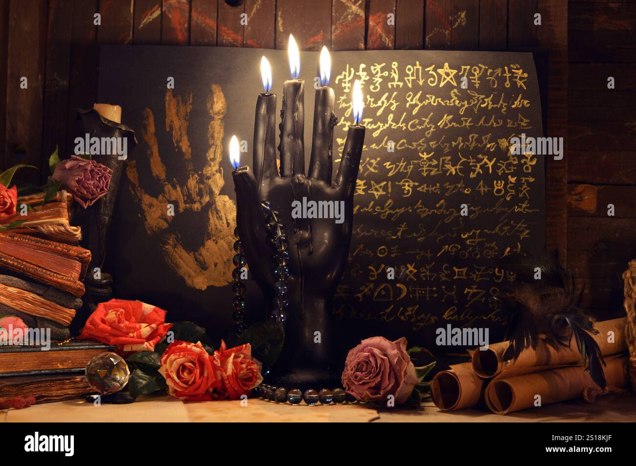 Mystic still life with magic spell book, roses and burning black ...
