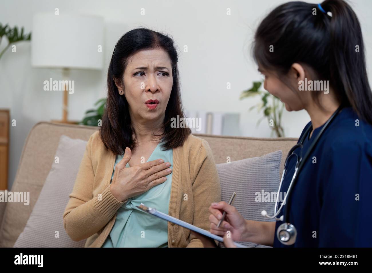 Compassionate caregiver and elderly patient consultation at home nurse ...