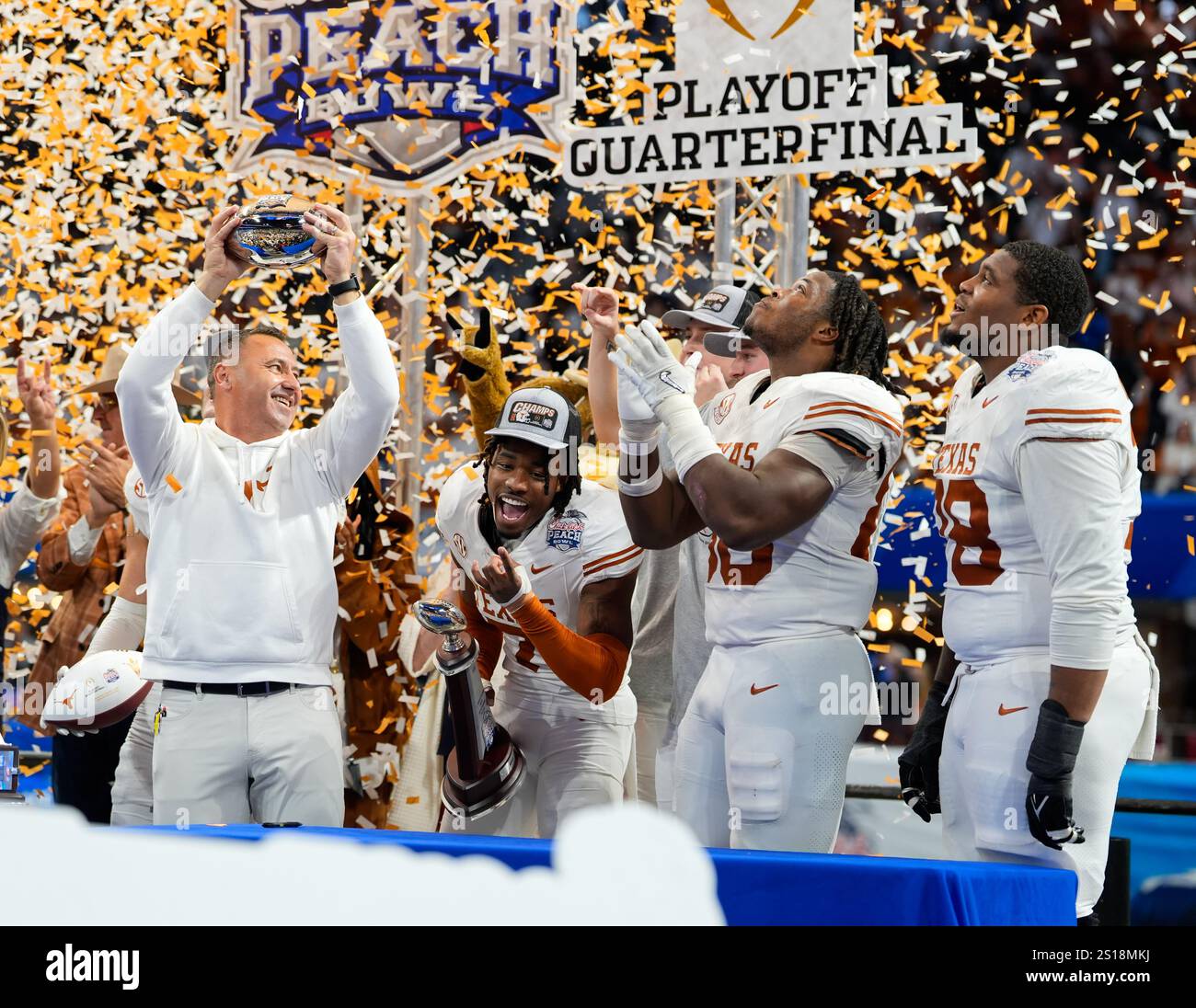 Head coach Steve Sarkisian (Texas Longhorns) holds up the Peach Bowl ...