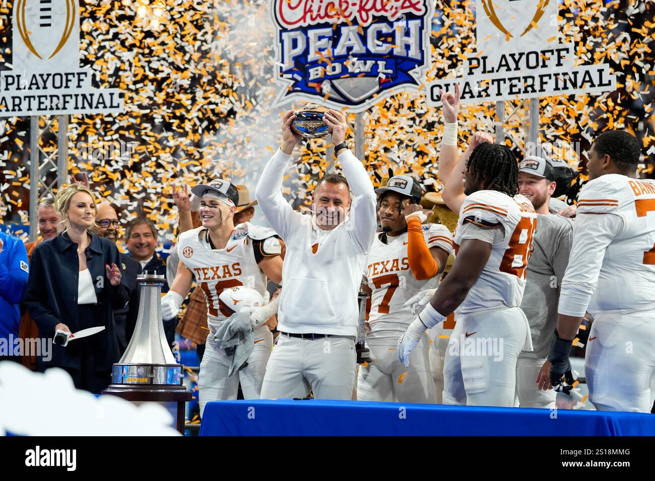 Head coach Steve Sarkisian (Texas Longhorns) holds up the Peach Bowl ...