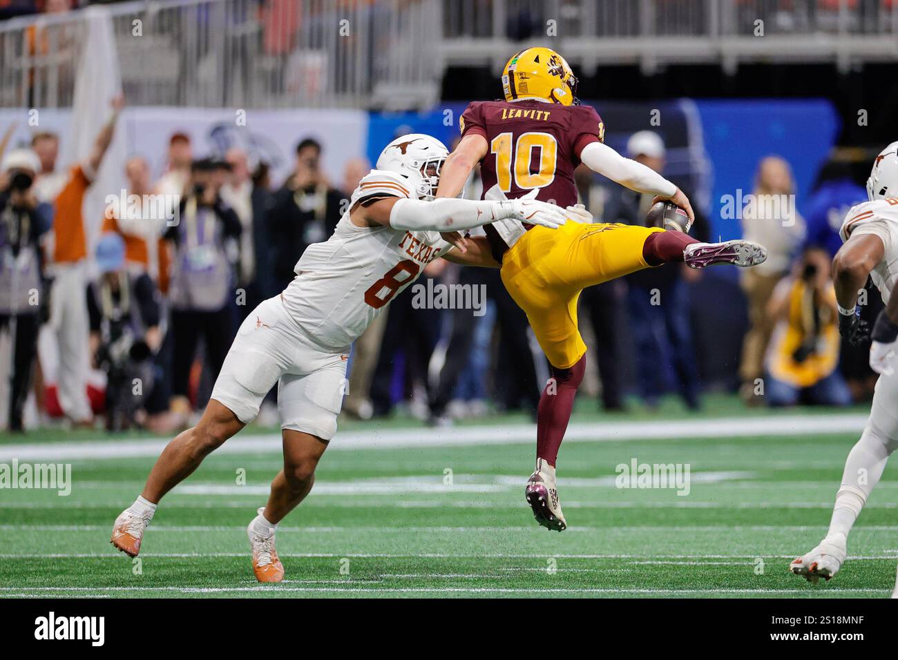 January 1, 2025: Sam Leavitt (10) of Arizona State is brought down by ...