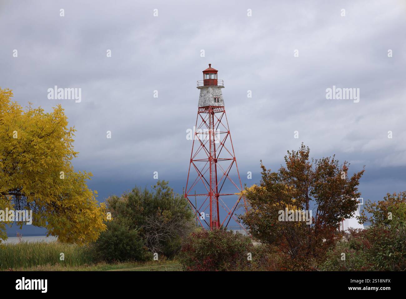 steel tower lighthouse amid autumn colors under heavy gray skies Stock ...