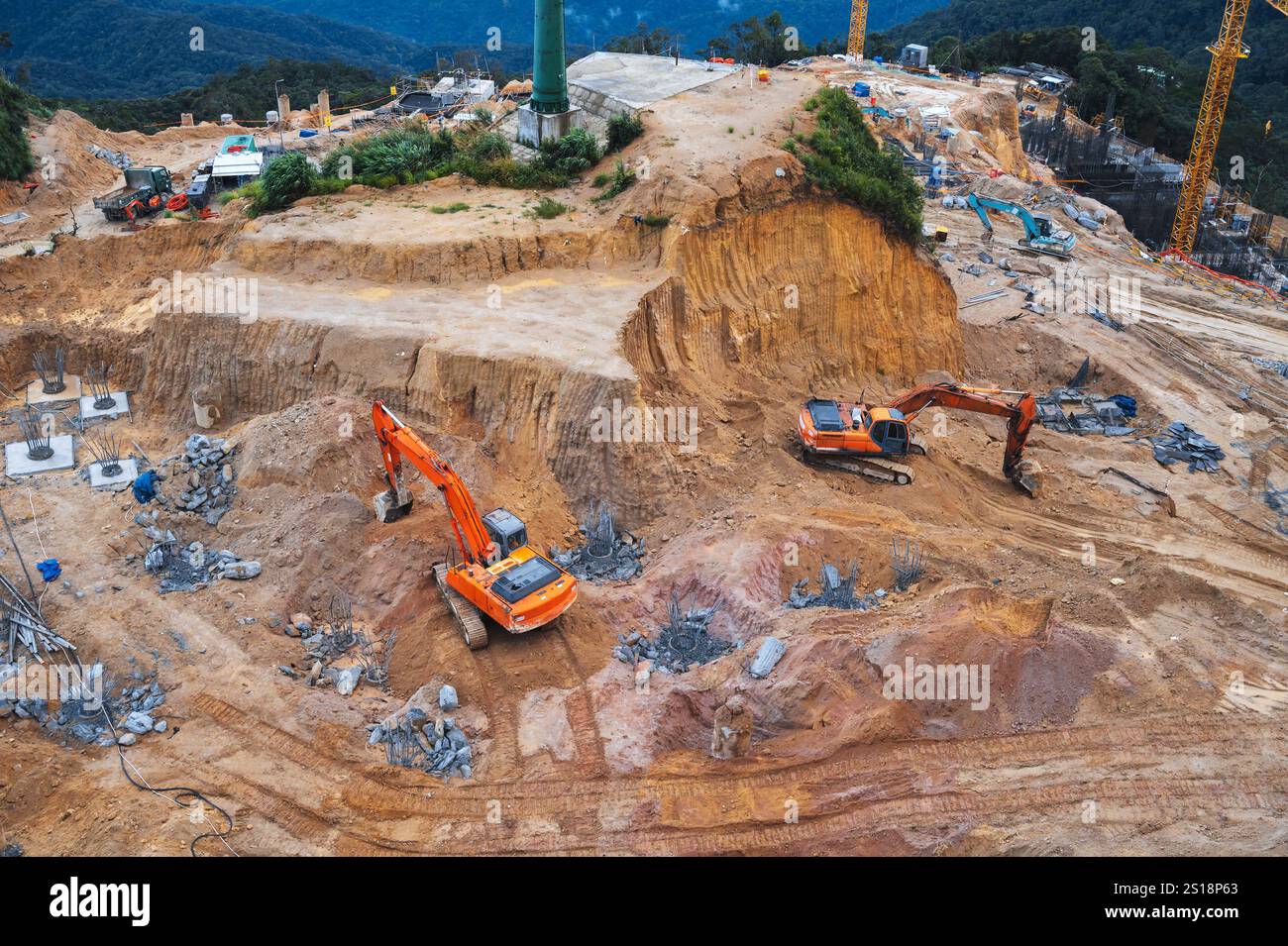 construction site with excavators digging a pit for the foundation of a ...