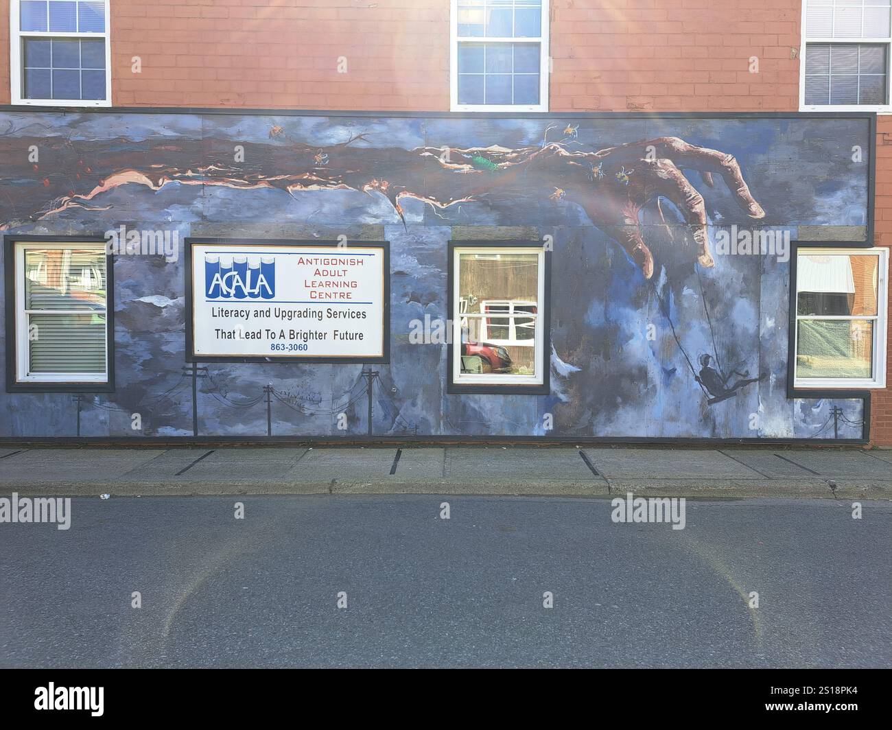 Mural of a tree branch arm and hand holding a swing in downtown ...