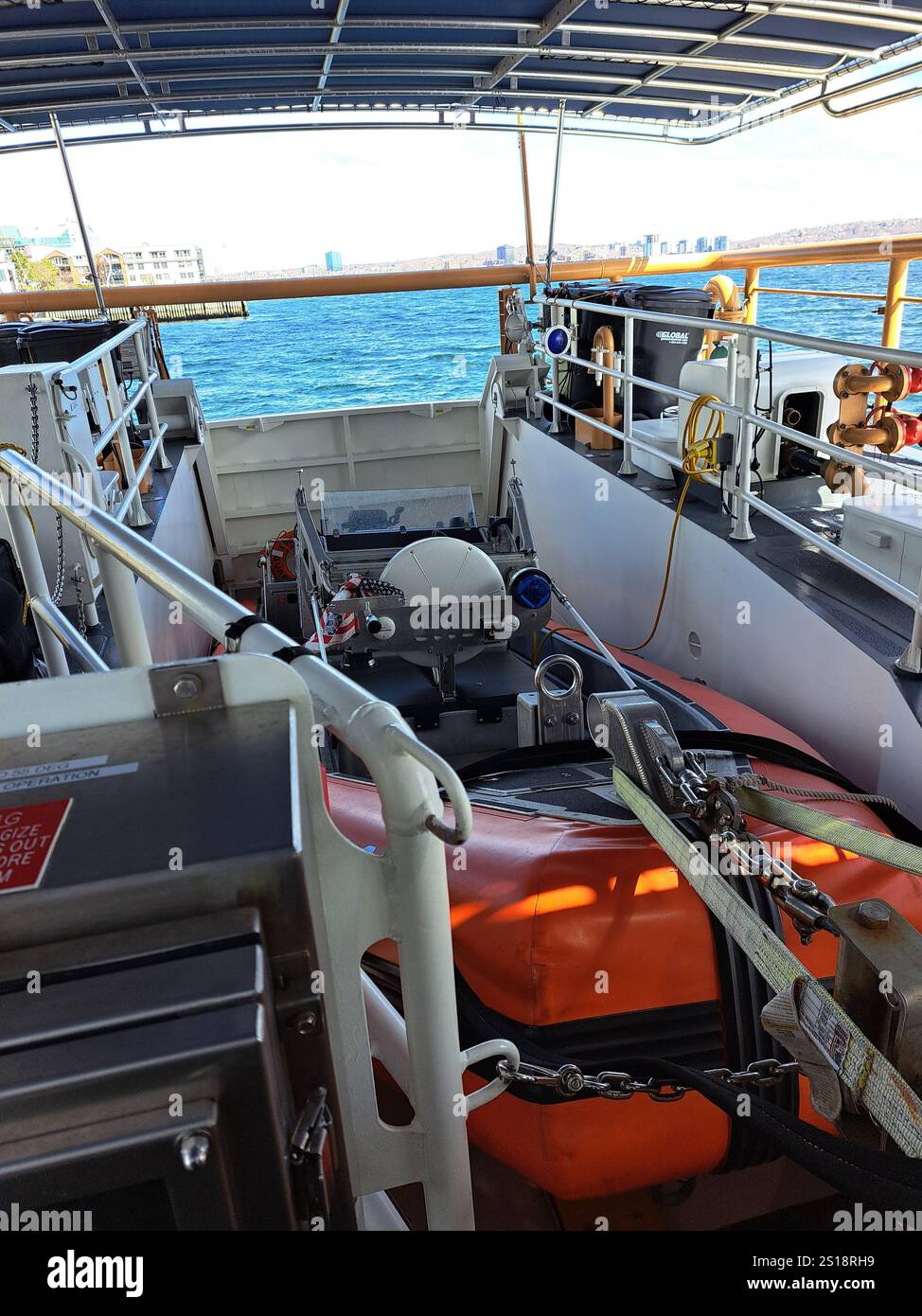 Life raft US Coast Guard boat docked at the waterfront boardwalk in ...