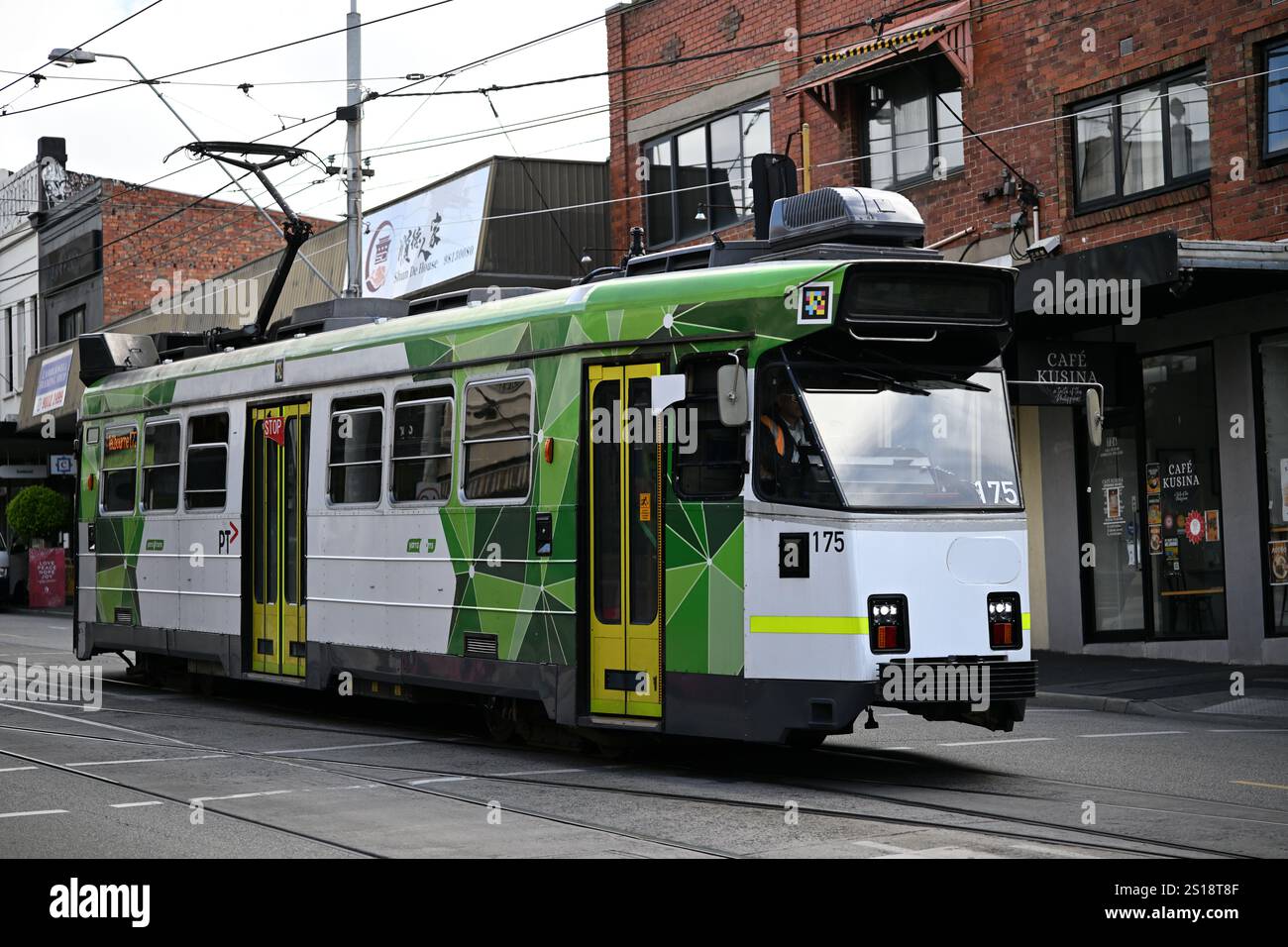 Z-class tram, featuring PTV livery, travelling past the Burke Rd shops ...