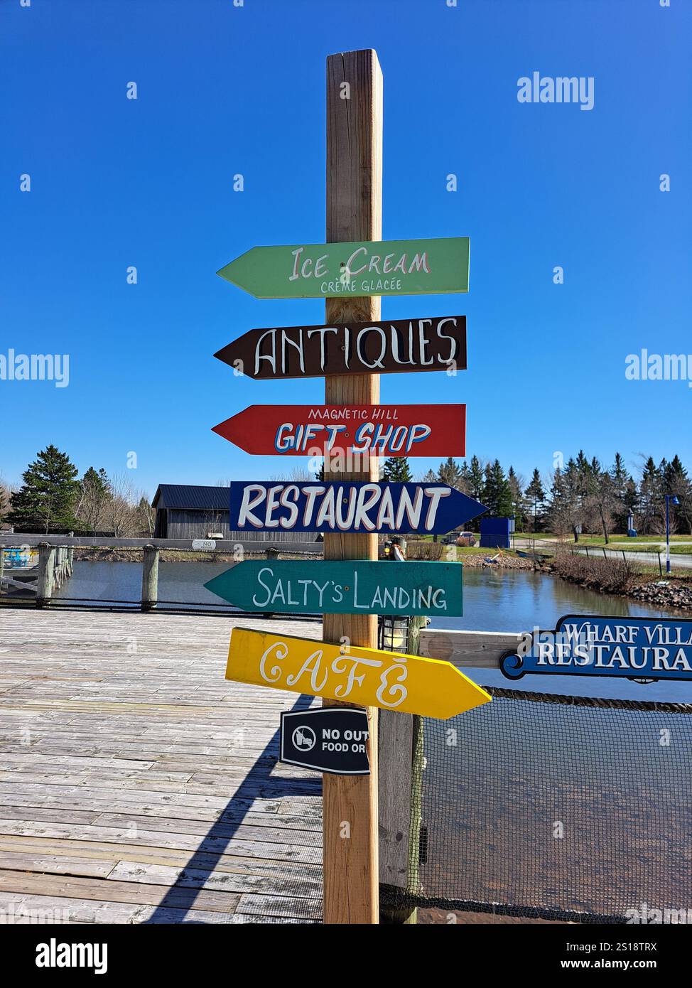 Colorful directional street signs at the wharf village at Magnetic Hill ...