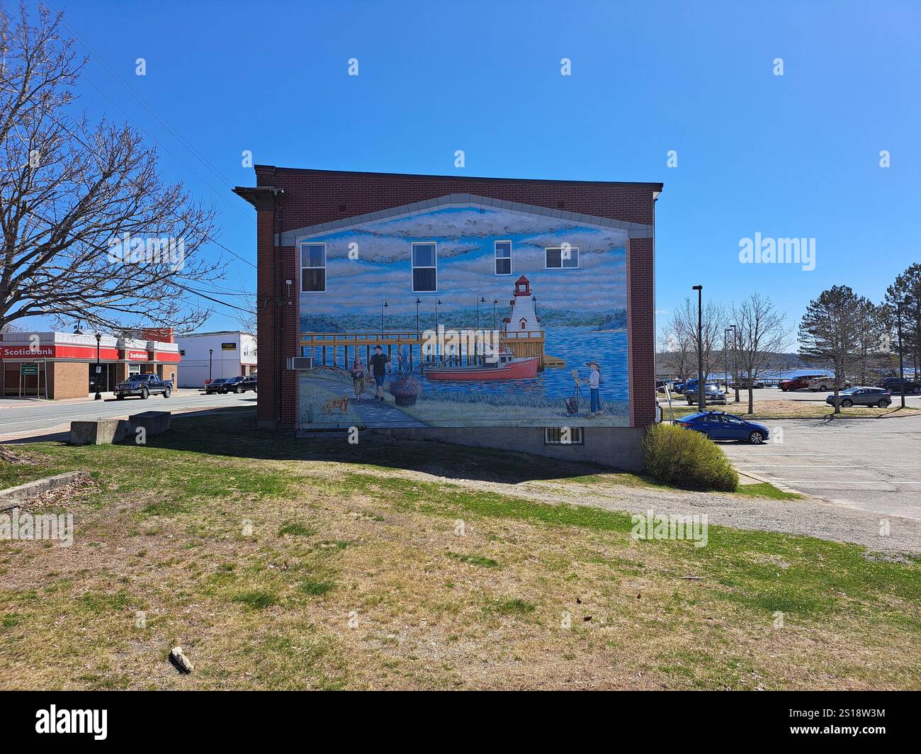 Mural of artist painting the lighthouse at the wharf in St. Stephen ...