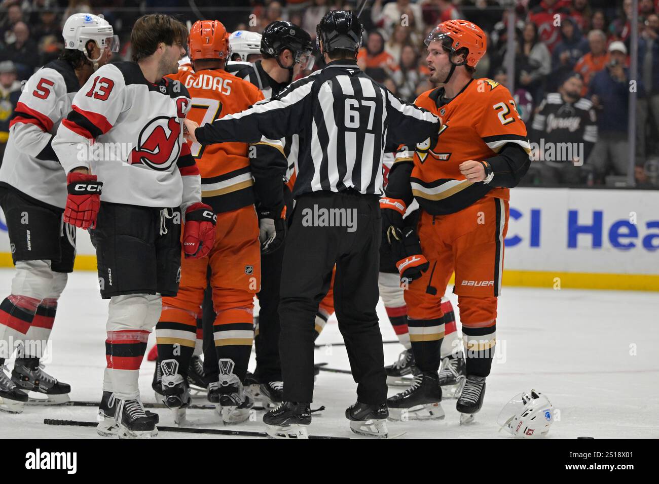 Linesman Devin Berg separates New Jersey Devils center Nico Hischier ...