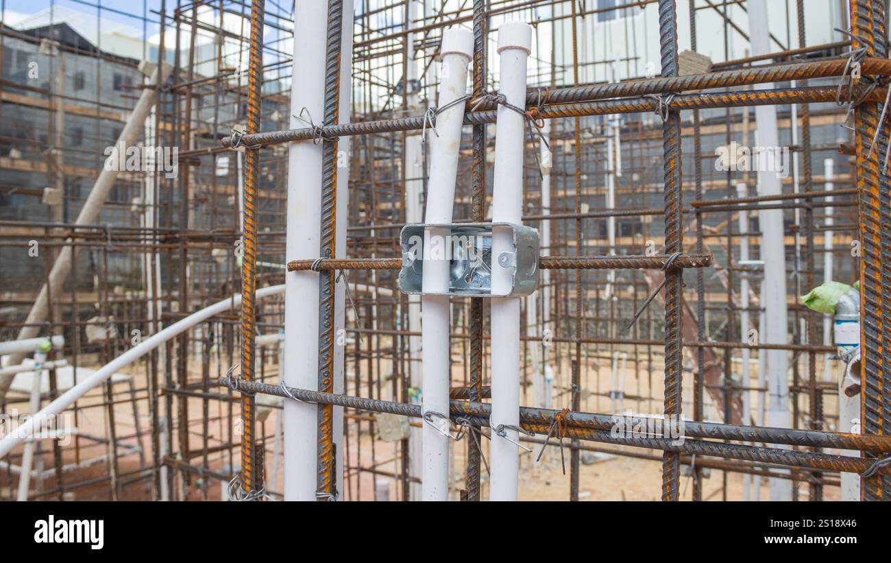 Interior of the house in electrical base construction with pipes and steel bars supporting the ...