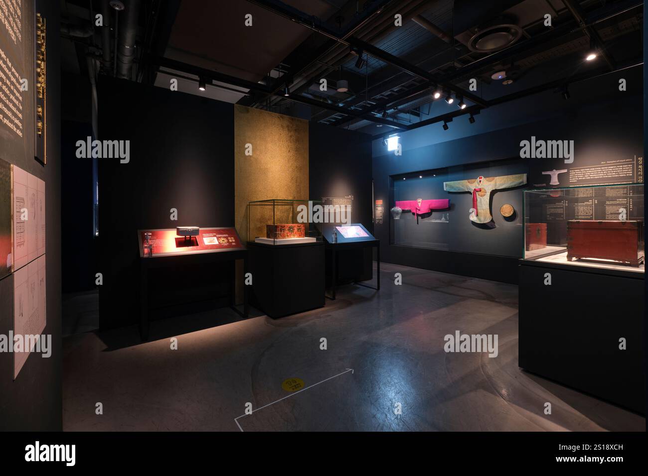 Various ancient objects on display, including robes and ornate chests ...