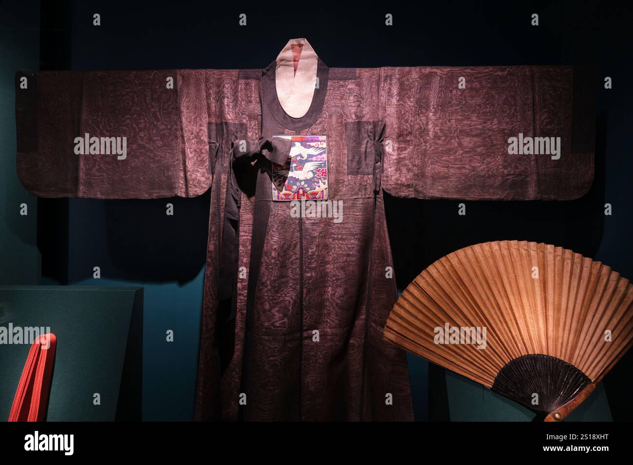 A fancy, dark purple, black silk robe and a fan. At the Museum of Craft ...