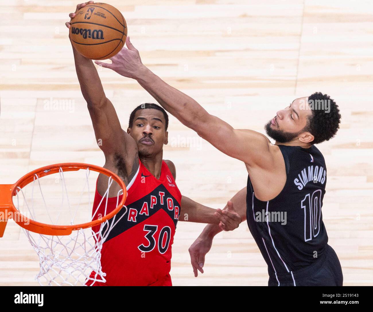 Toronto, Canada. 1st Jan, 2025. Ochai Agbaji (L) of Toronto Raptors dunks during the 2024-2025 ...
