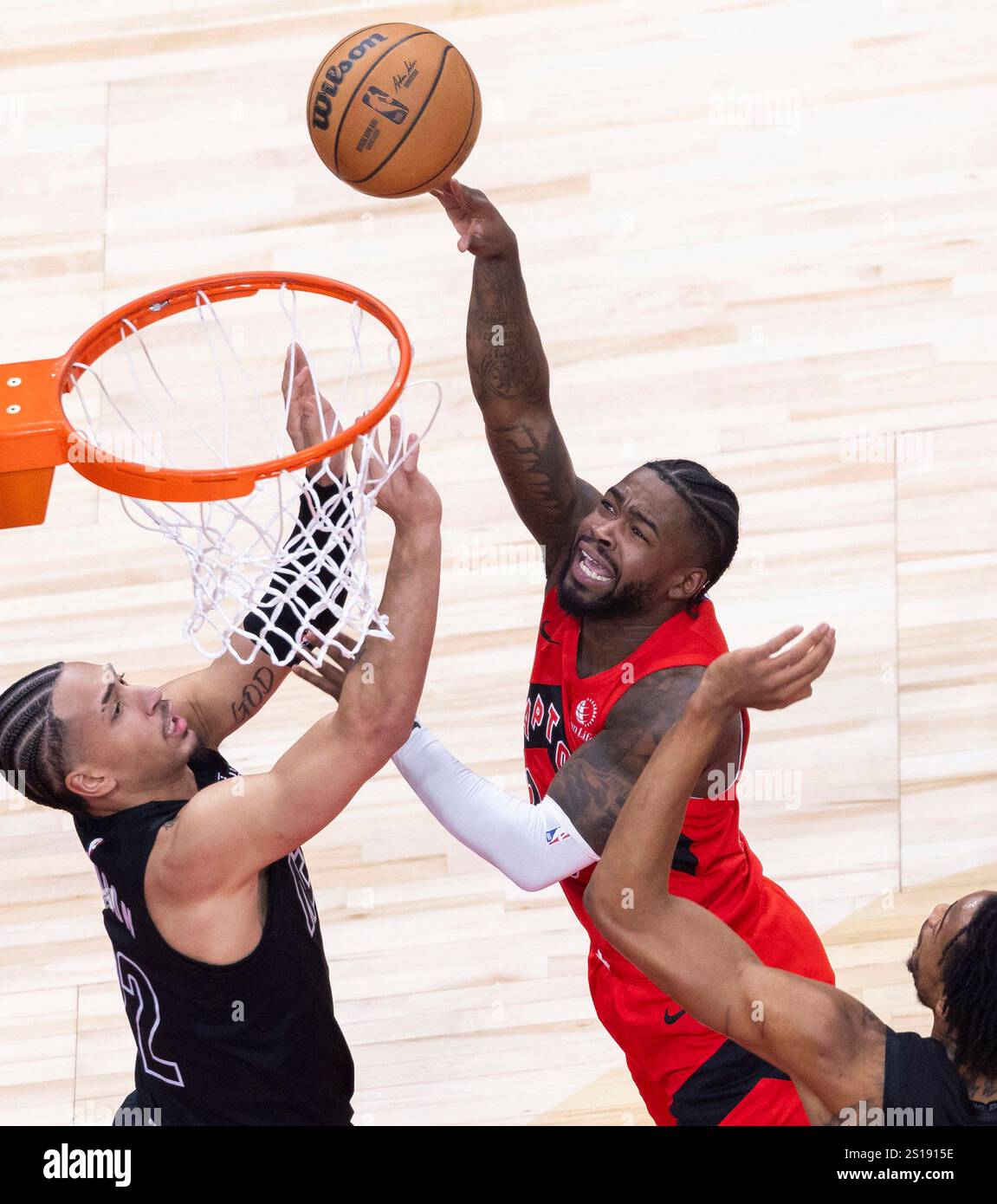 Toronto, Canada. 1st Jan, 2025. Jamal Shead (C) of Toronto Raptors ...