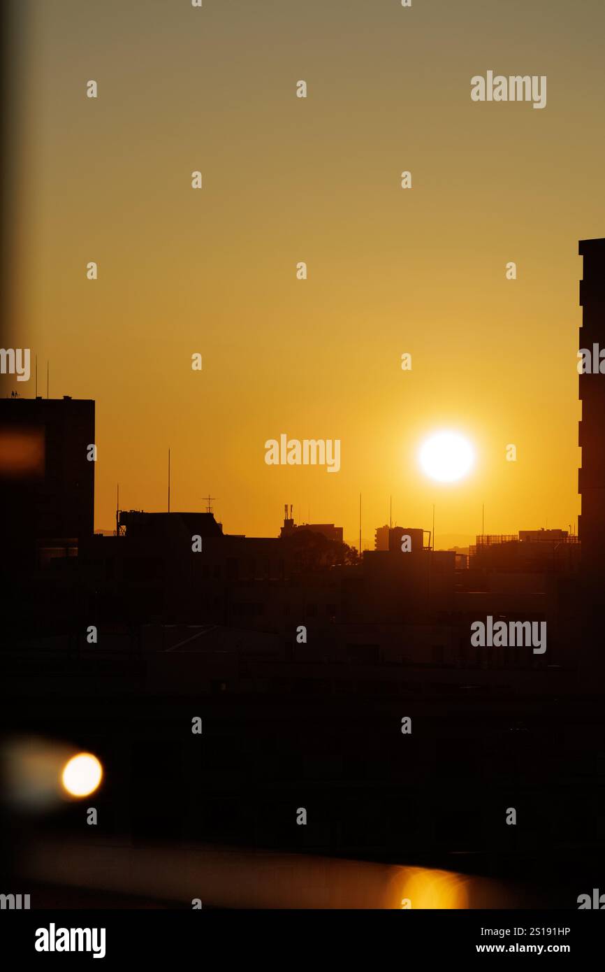 The morning sun appears low on cloudless golden hour dawn sky. Its ...