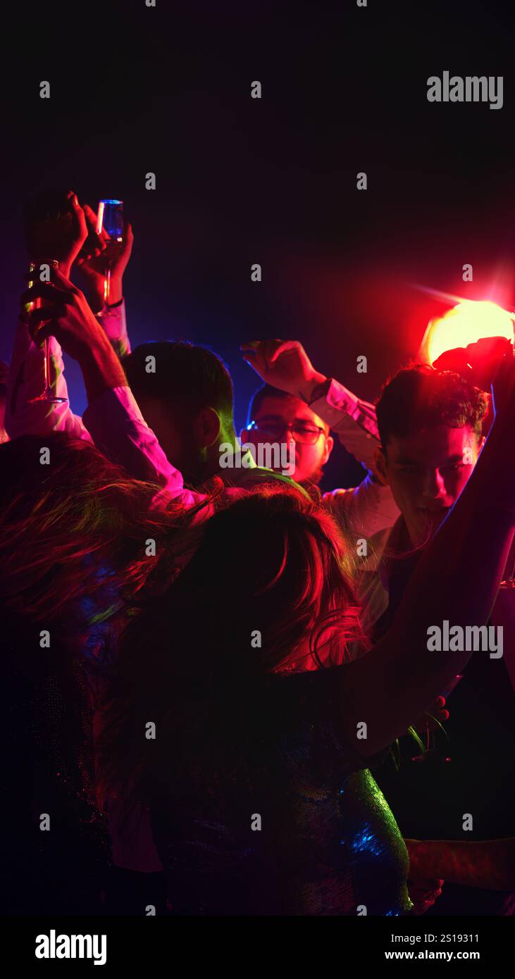 Happy birthday celebration. Champagne glasses shimmer as crowd dances ...