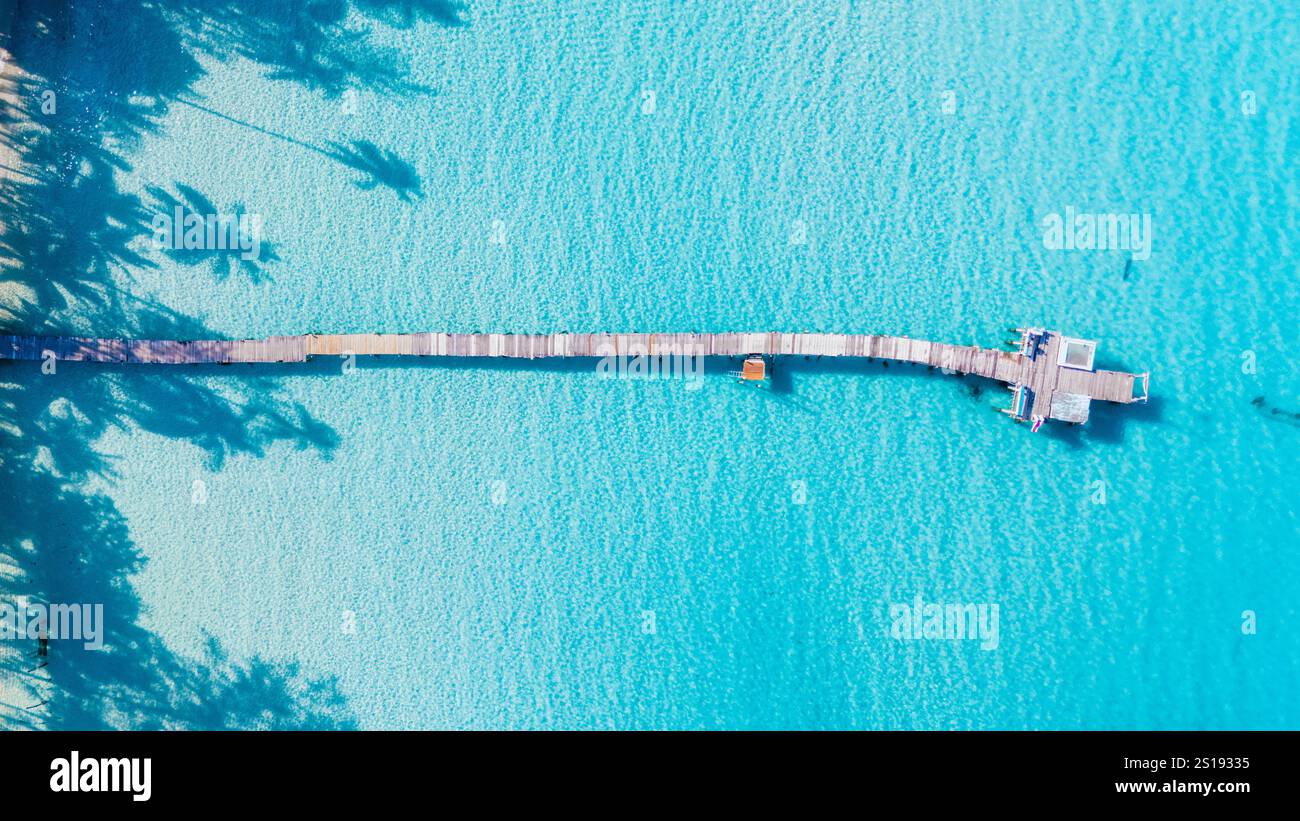 The stunning turquoise waters of Koh Kood cradle a long wooden pier ...