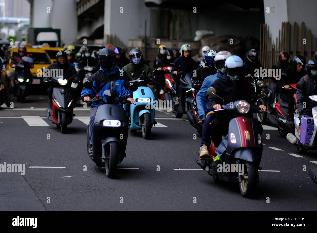 Several early morning commuters ride motorbikes as a preferred means of ...