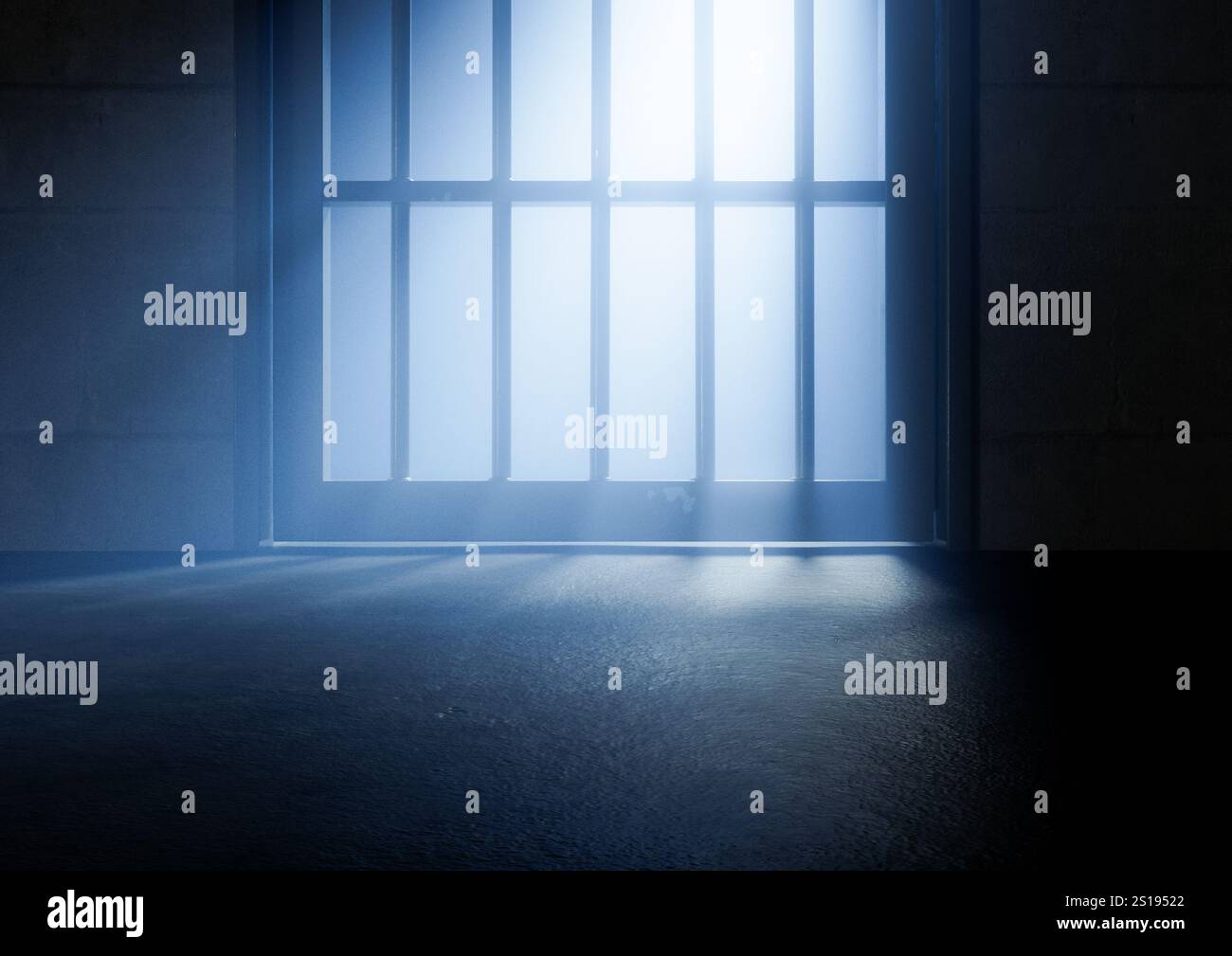 A closeup of a spolight behind jail cells iron bars casting shadows on the concrete prison floor ...