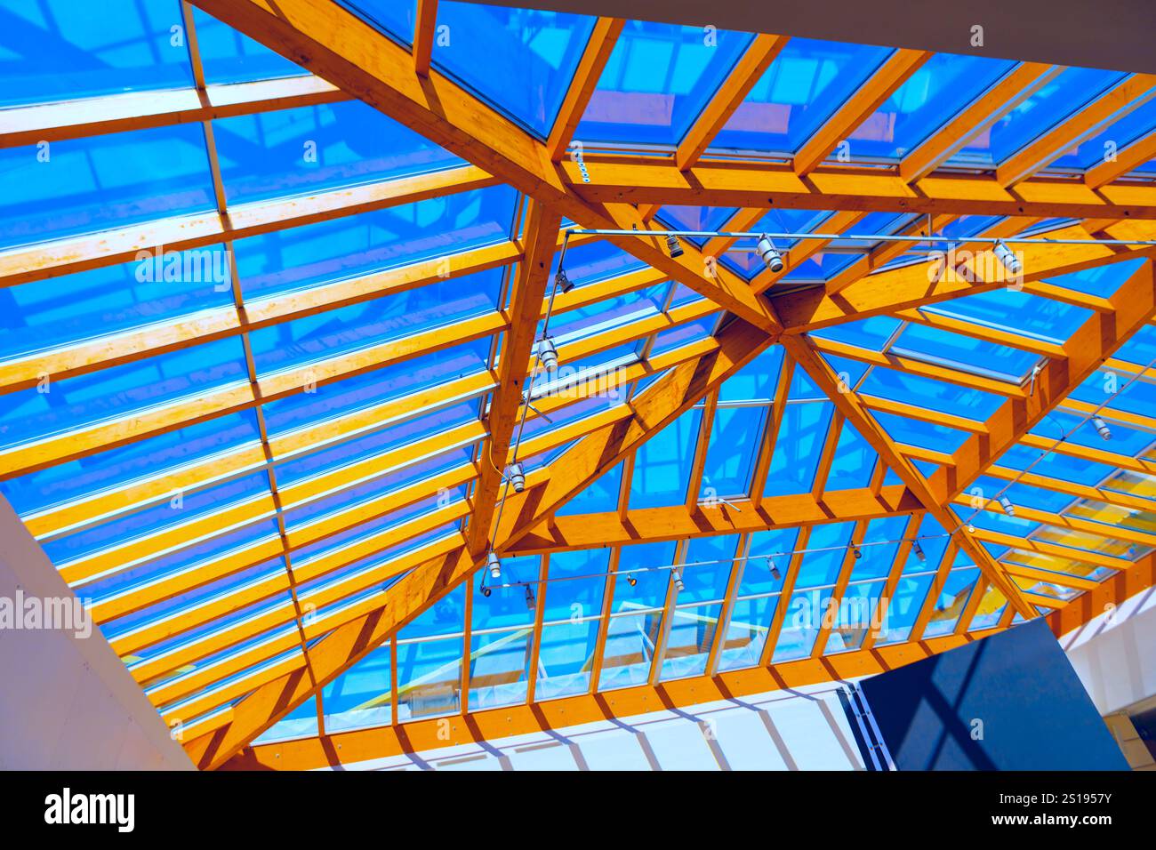 Modern architectural structure with wooden framework supporting glass ...