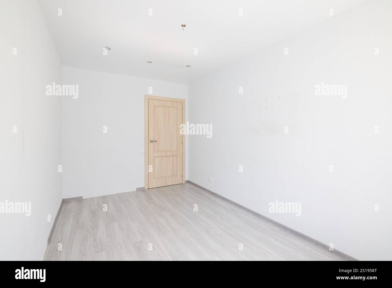 A spacious, empty room with beautifully lightcolored walls and flooring ...