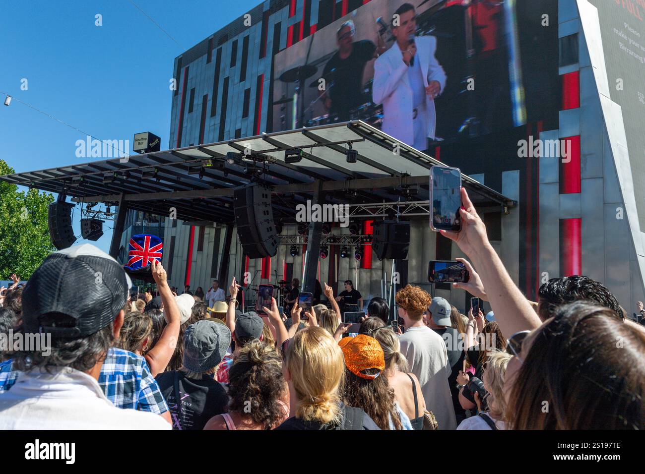 Fans cheer with excitement as Robbie Williams takes the stage for an ...