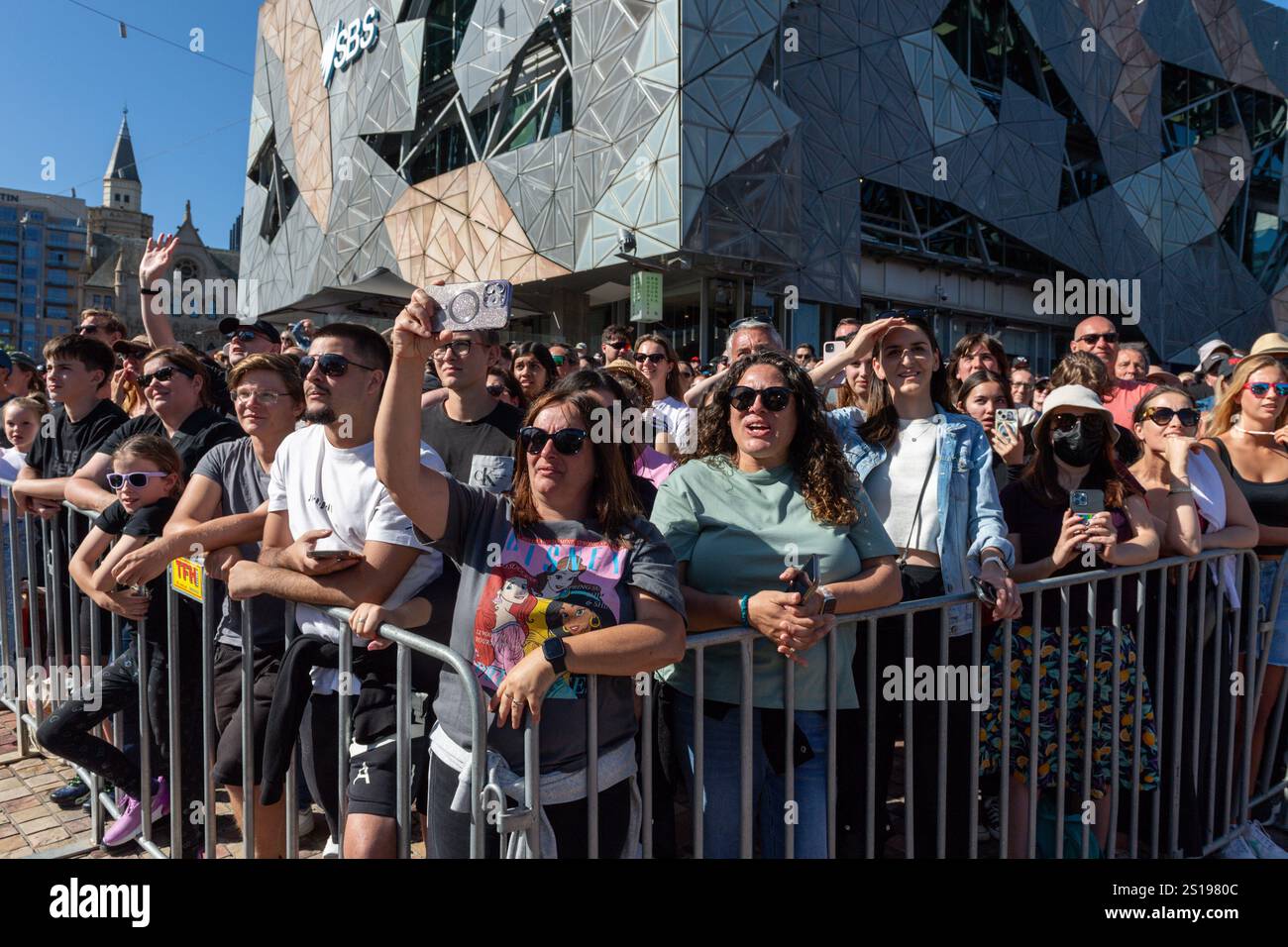 Fans cheer with excitement as Robbie Williams takes the stage for an ...