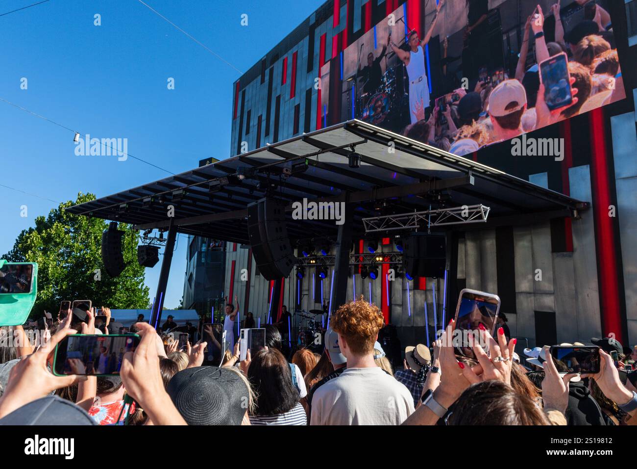 Fans cheer with excitement as Robbie Williams takes the stage for an ...