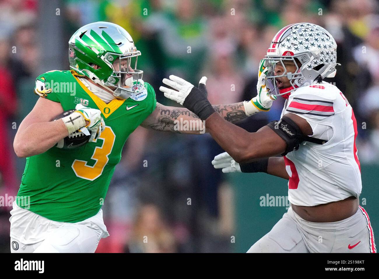 Oregon tight end Terrance Ferguson (3) stiff-arms Ohio State safety ...