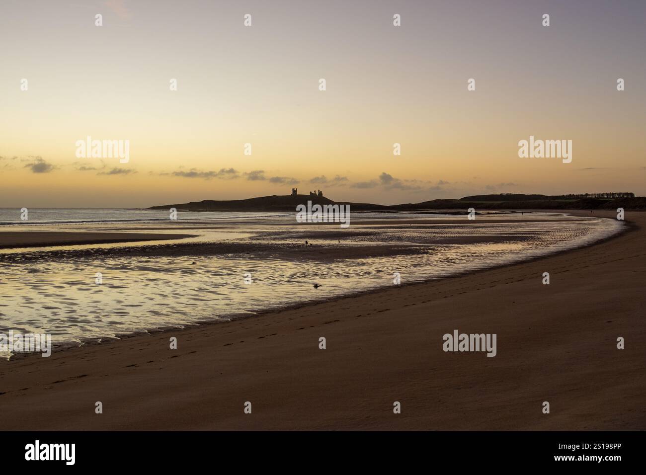 Autumn sunrise over Embleton Bay and Dunstanburgh Castle Stock Photo ...