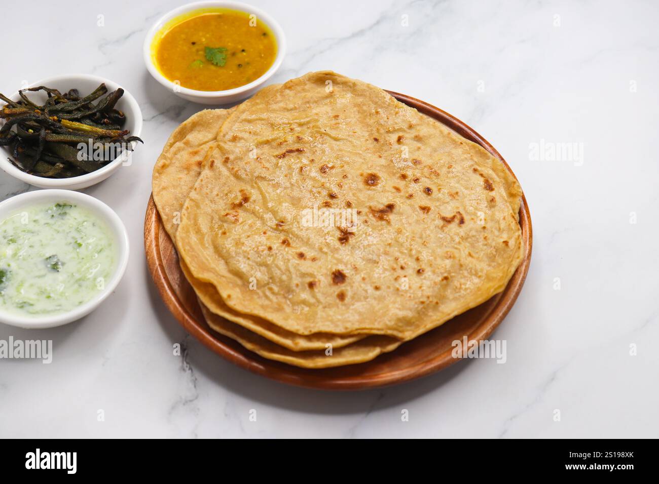 Roti and Sabzi. Indian vegetarian Thali includes bhindi fry, yellow ...