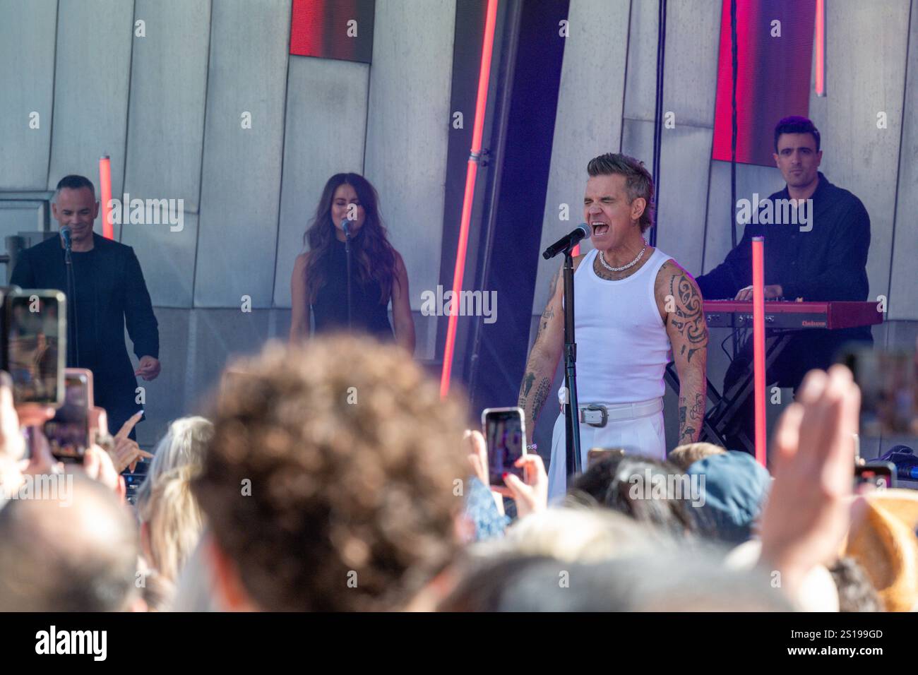Rock Star Robbie Williams belts out his big hits on stage at a free ...