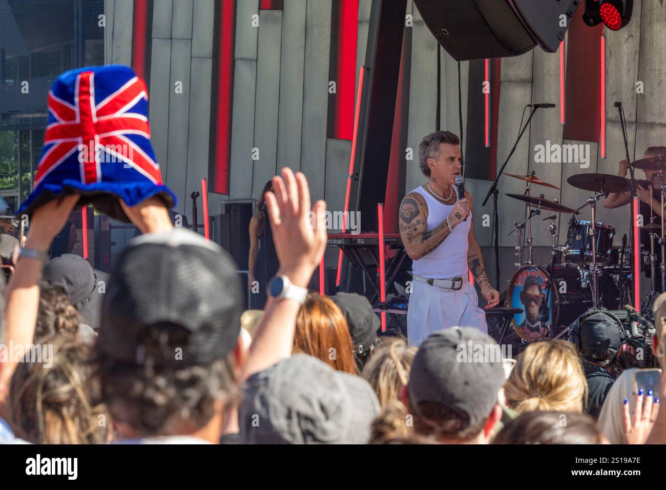 Fans show their excitement as Robbie Williams takes the stage at a free ...