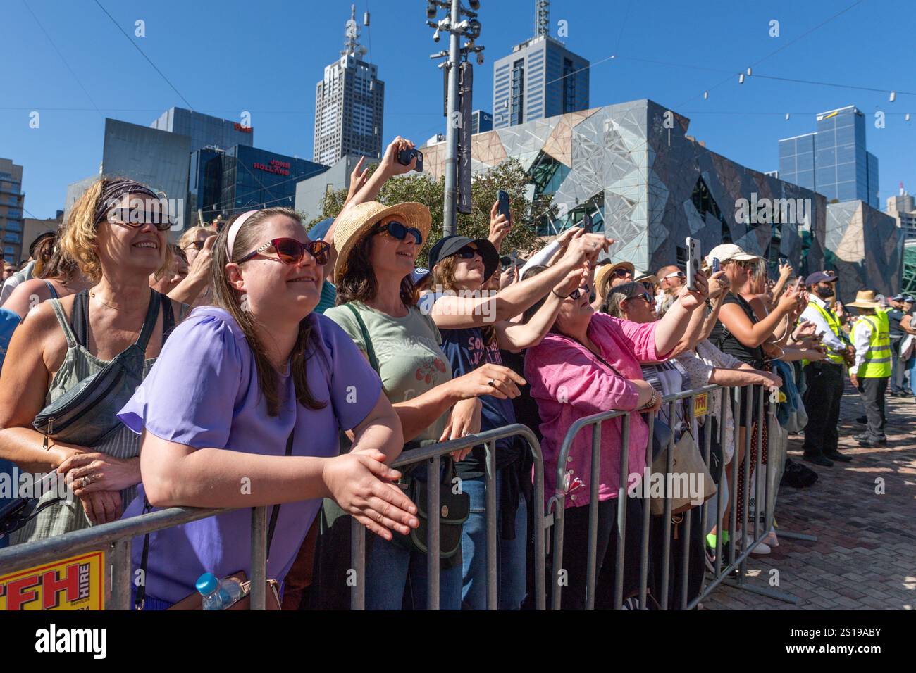 Fans cheer with excitement as Robbie Williams takes the stage for an ...