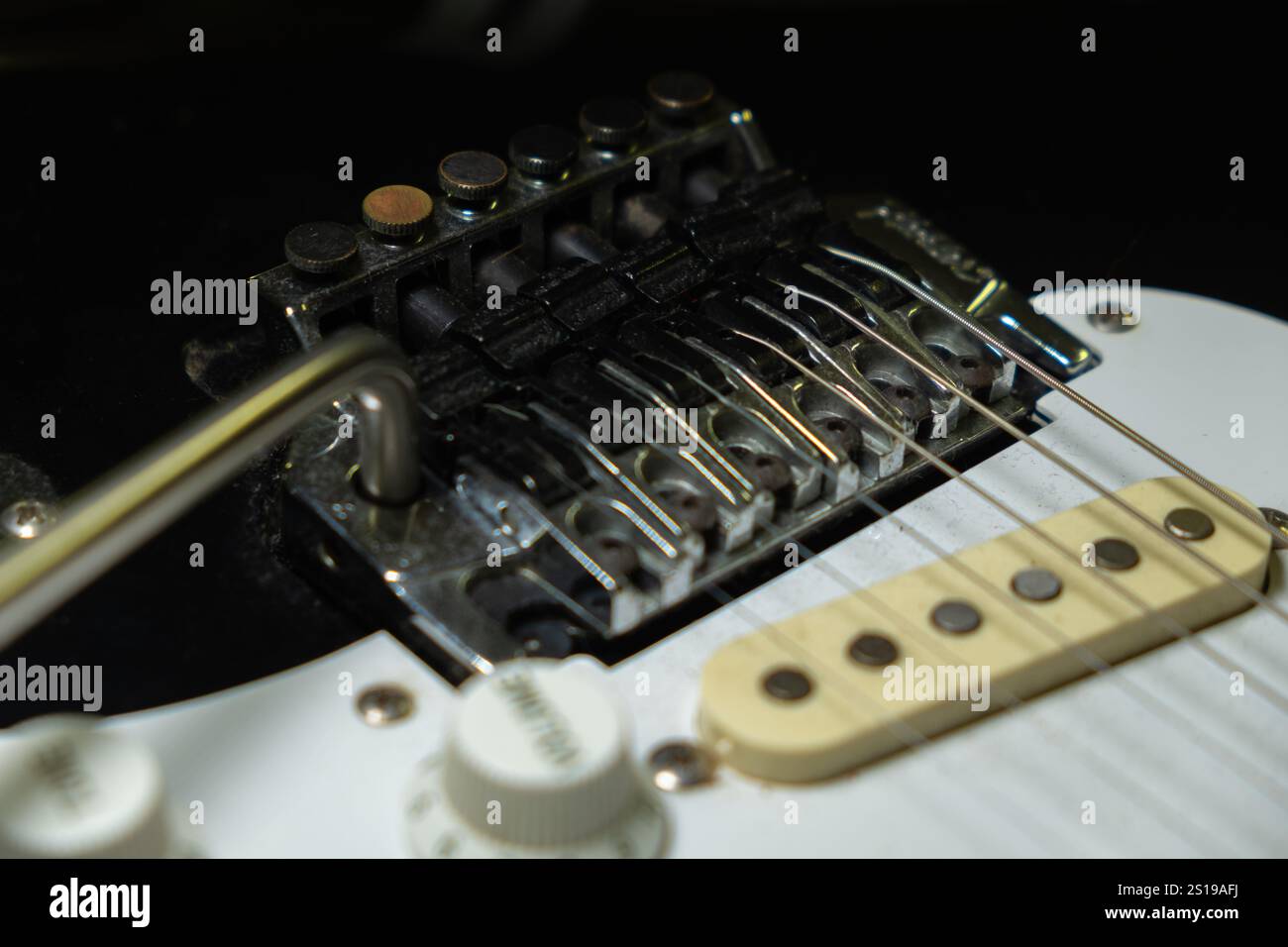 detail of an electric guitar bridge, strings and volume control Stock ...