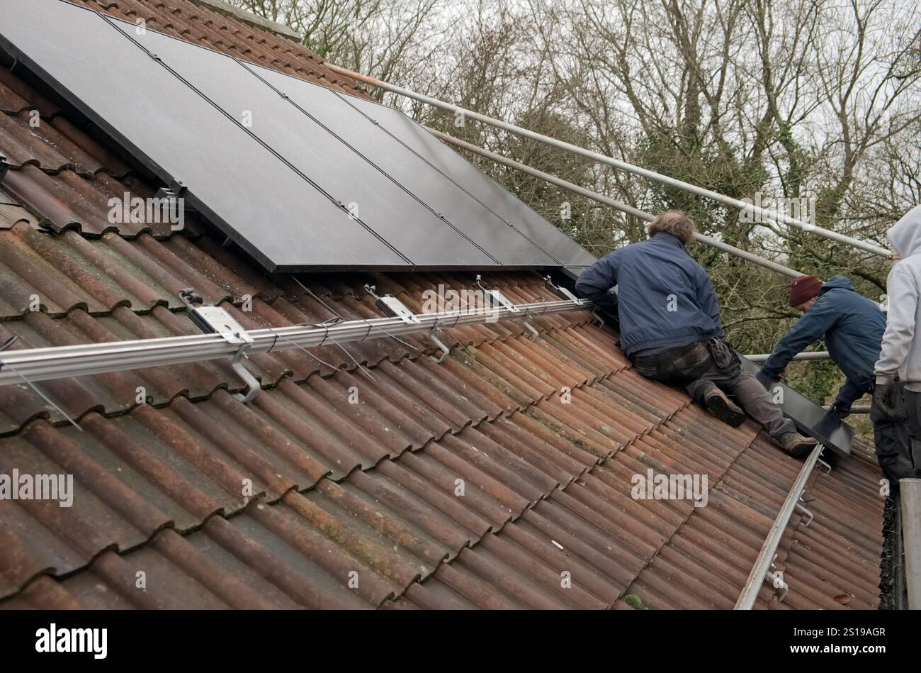 Installing Photovoltaic panels on a south facing 40 degree pitch double roman clay tile roof in ...