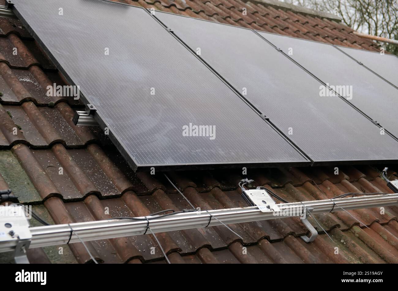 Installing Photovoltaic panels on a south facing 40 degree pitch double roman clay tile roof in ...