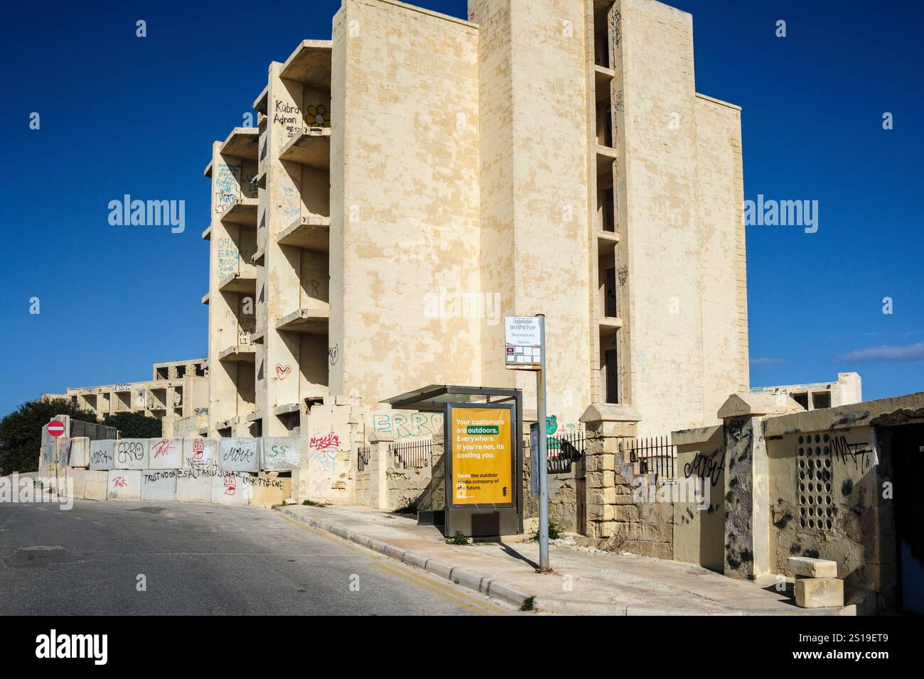A bus stop by the abandoned Jerma Palace Hotel, Marsaskala, Malta Stock ...