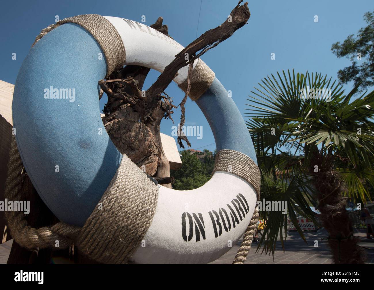 life belt with warning sign on risks and hazards in seafaring and ...