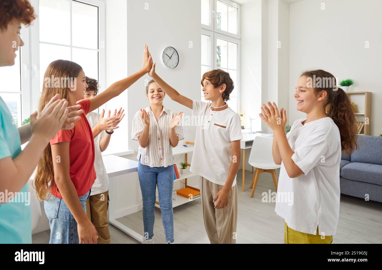 Students High-Fiving Each Other During Learning In School Classroom ...