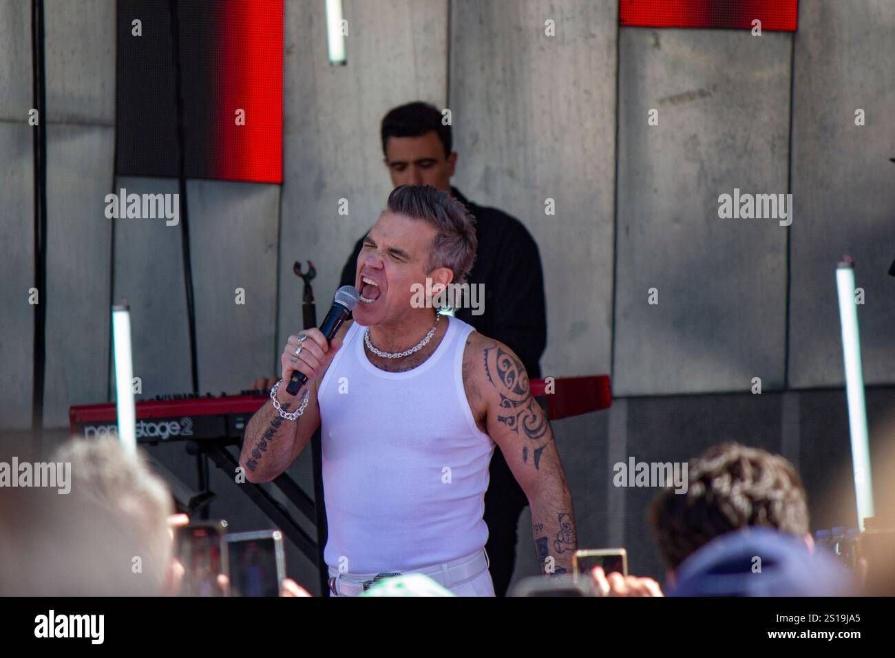 Robbie Williams performing for the crowd. Robbie Williams performing a ...