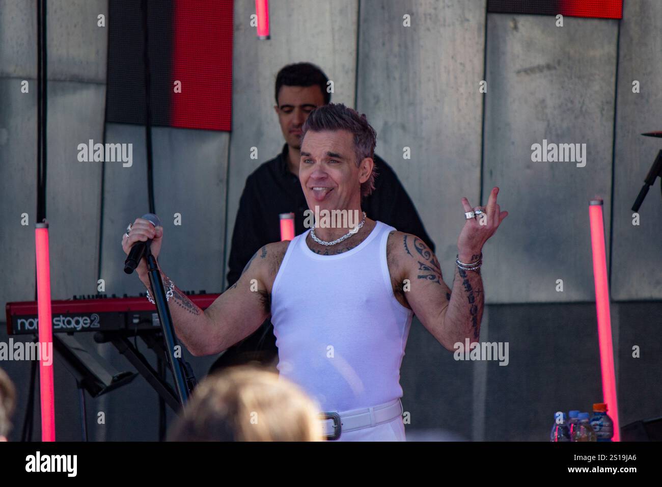 Robbie Williams performing for the crowd. Robbie Williams performing a ...