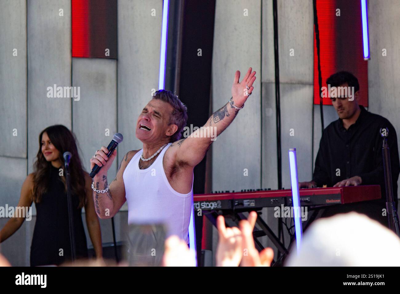 Robbie Williams performing for the crowd. Robbie Williams performing a ...