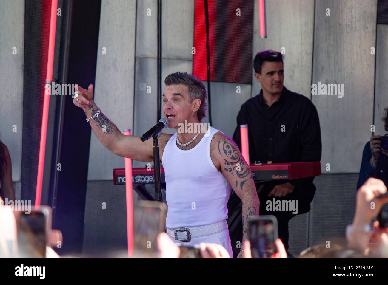 Robbie Williams performing for the crowd. Robbie Williams performing a ...