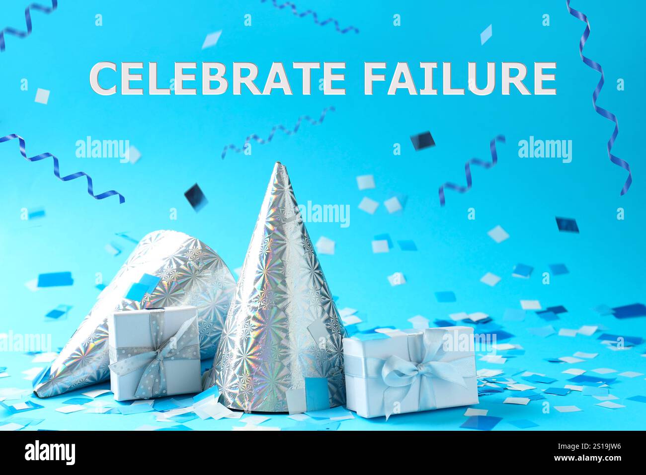Celebrate failure. Gift boxes and party hats under falling confetti and ...